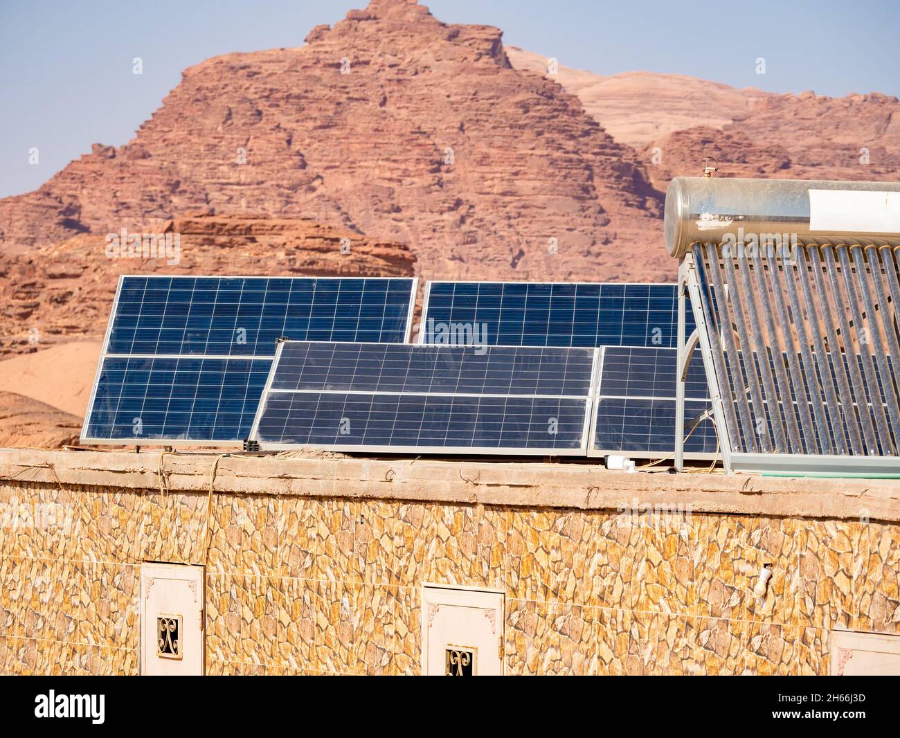 Photovoltaic solar panels on top of a building in Wadi Rum desert ...