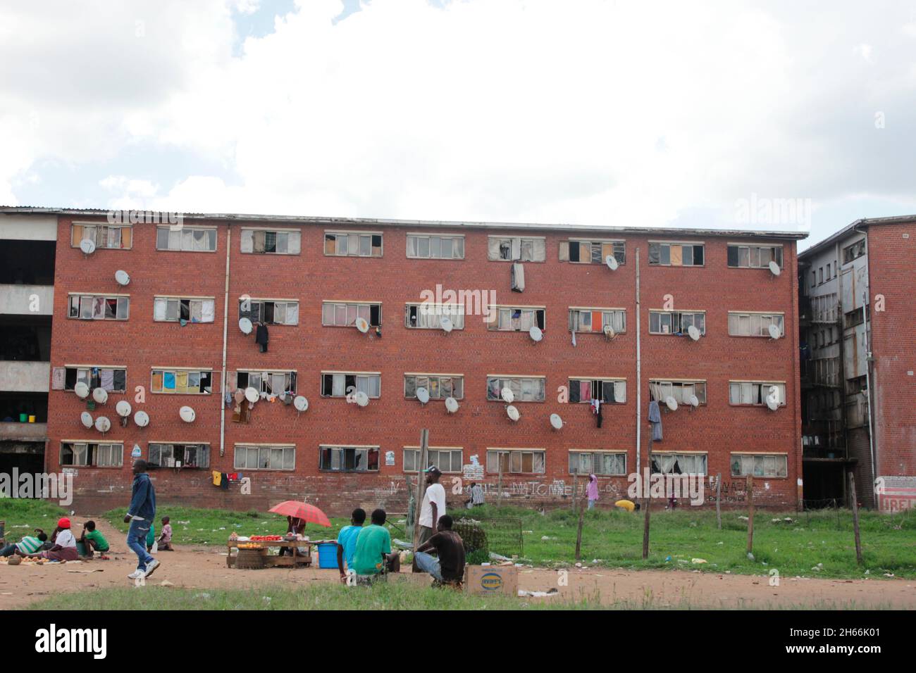 Satelitte dishes are seen hanging out of windows outside a block of ...