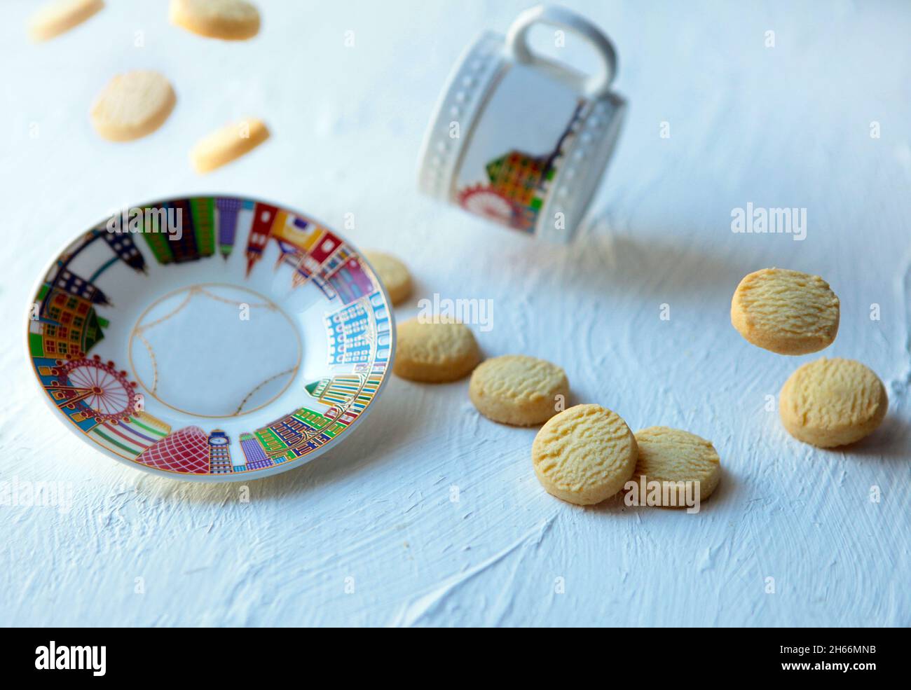 flying biscuits, plate and cup of tea. Falling cookies with mug. Food ...