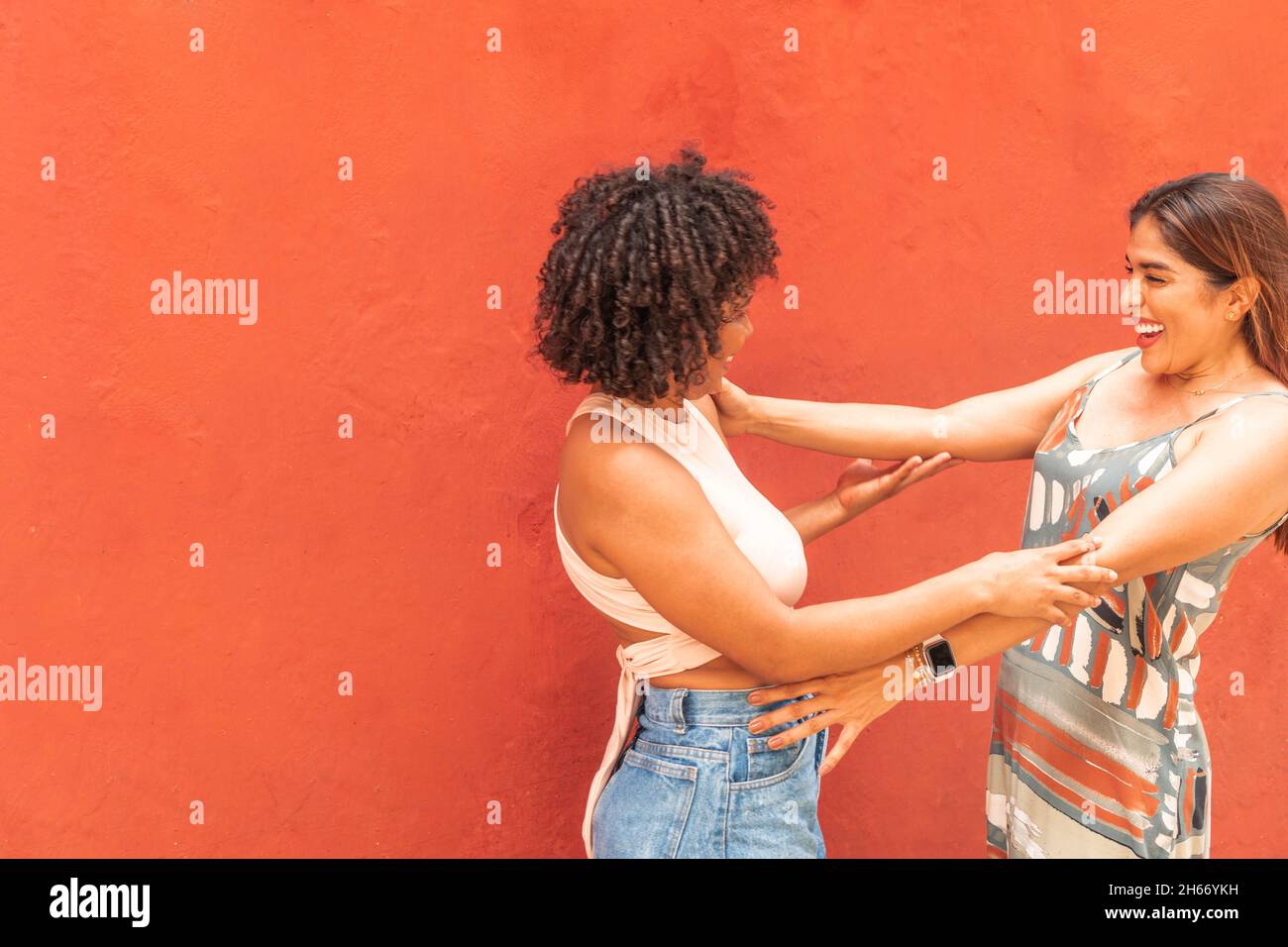 friends greeting each other after meeting on the street Stock Photo - Alamy