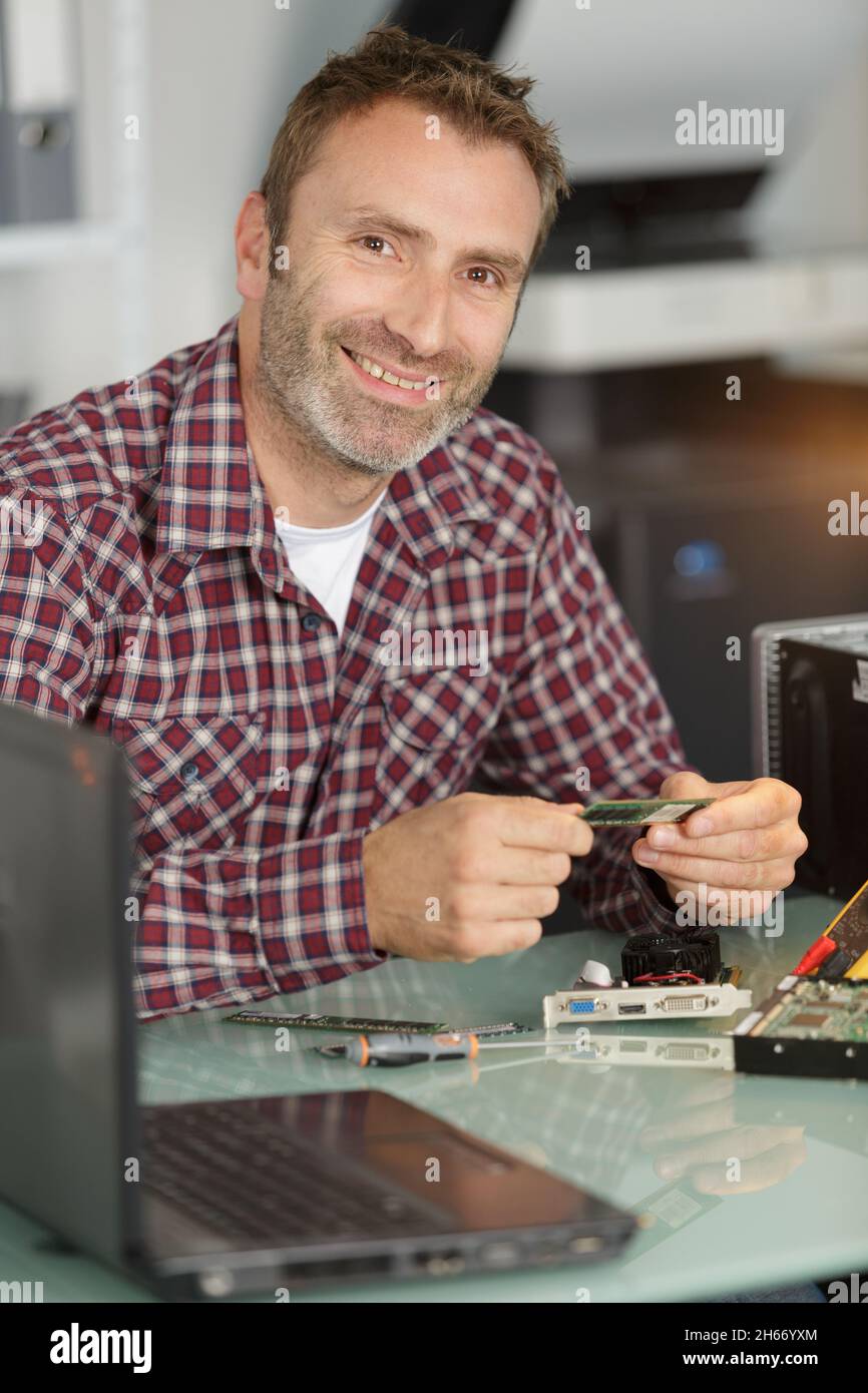 happy man fixing electronics Stock Photo - Alamy