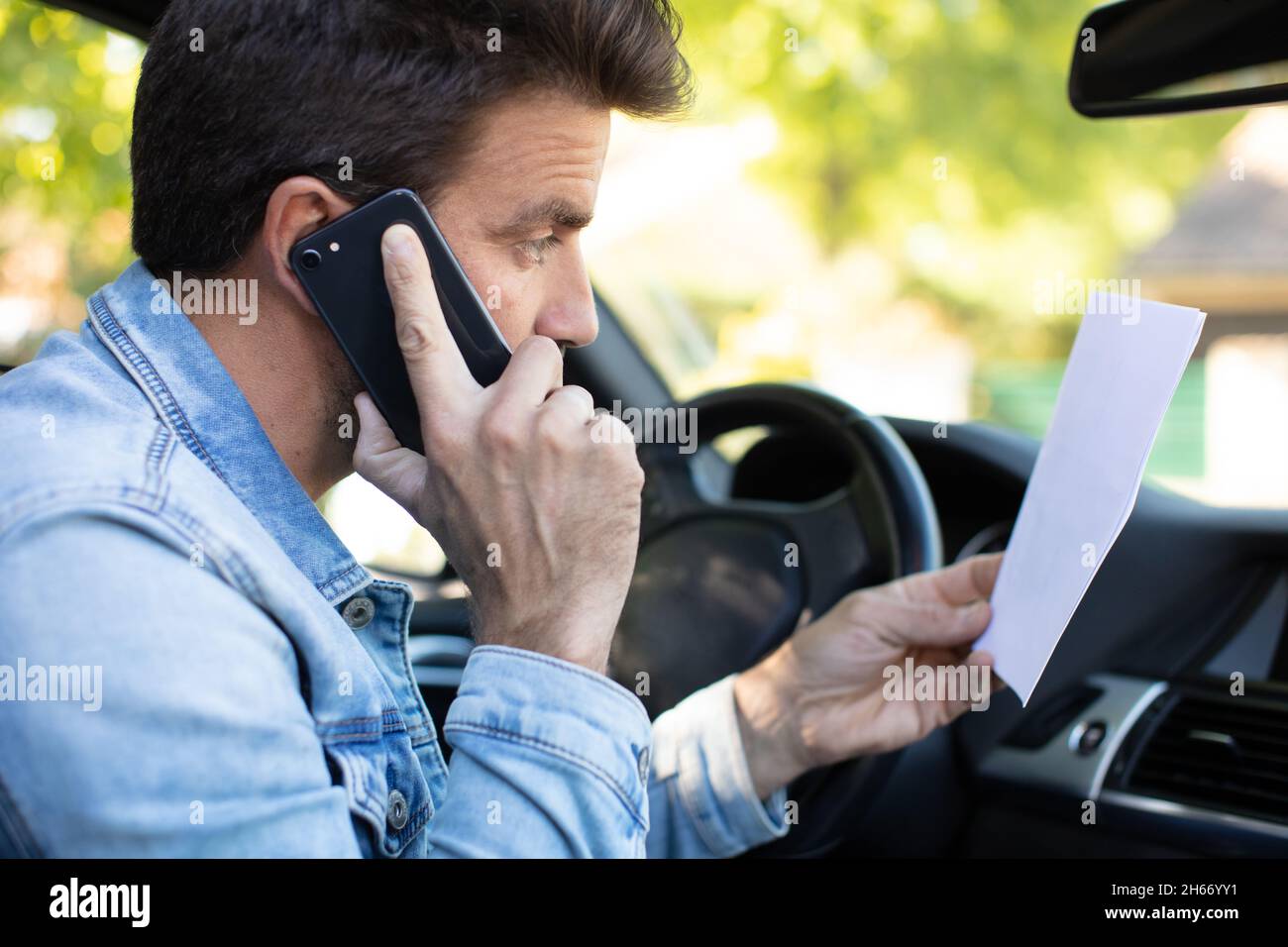 man sat in parked car making telephone call Stock Photo - Alamy