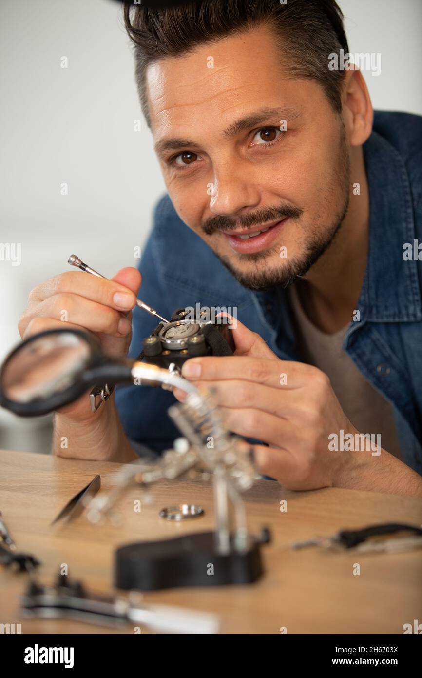 a man fixing mechanical watch Stock Photo - Alamy