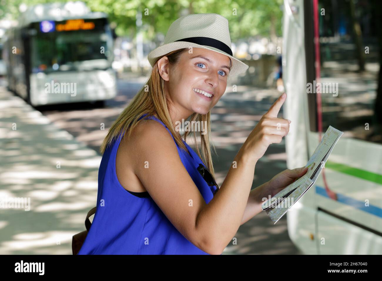 young woman waiting bus at station Stock Photo - Alamy