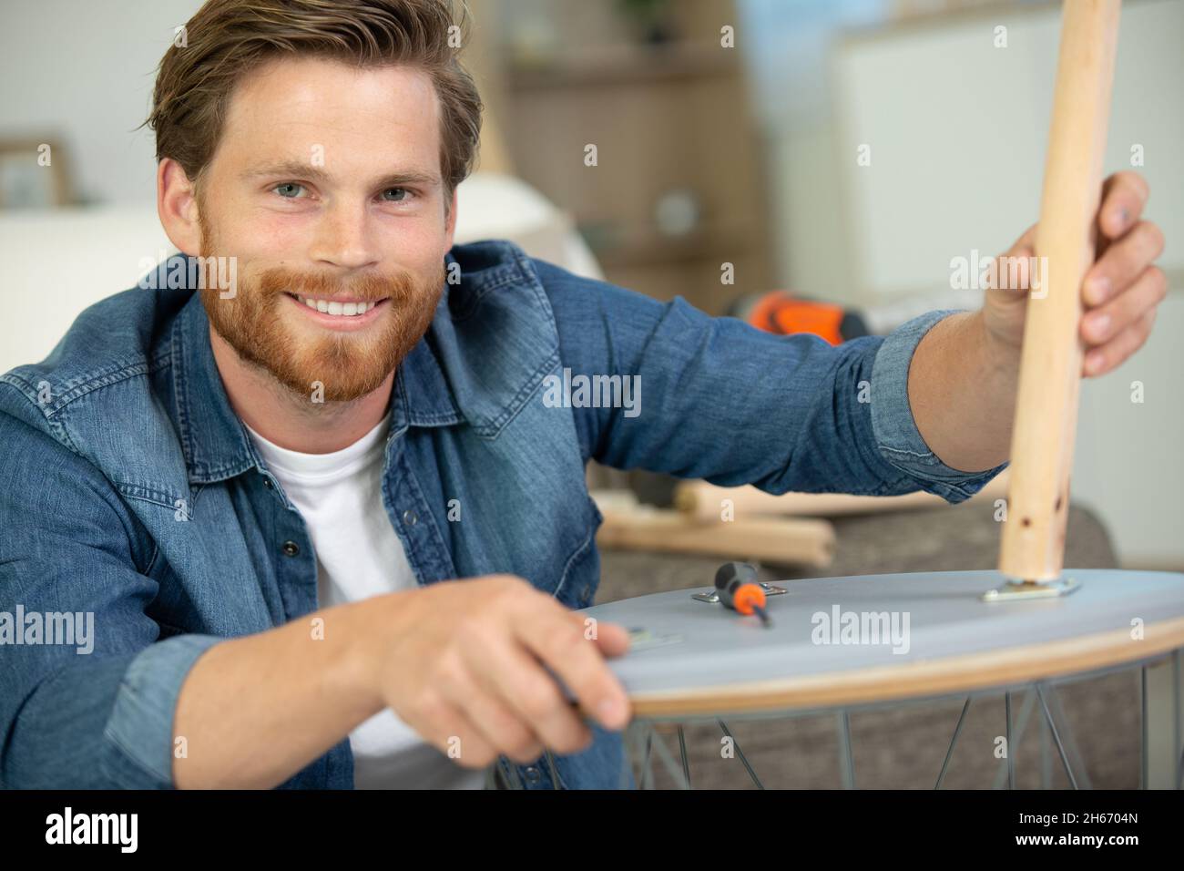 young carpenter smiling at the camera Stock Photo - Alamy