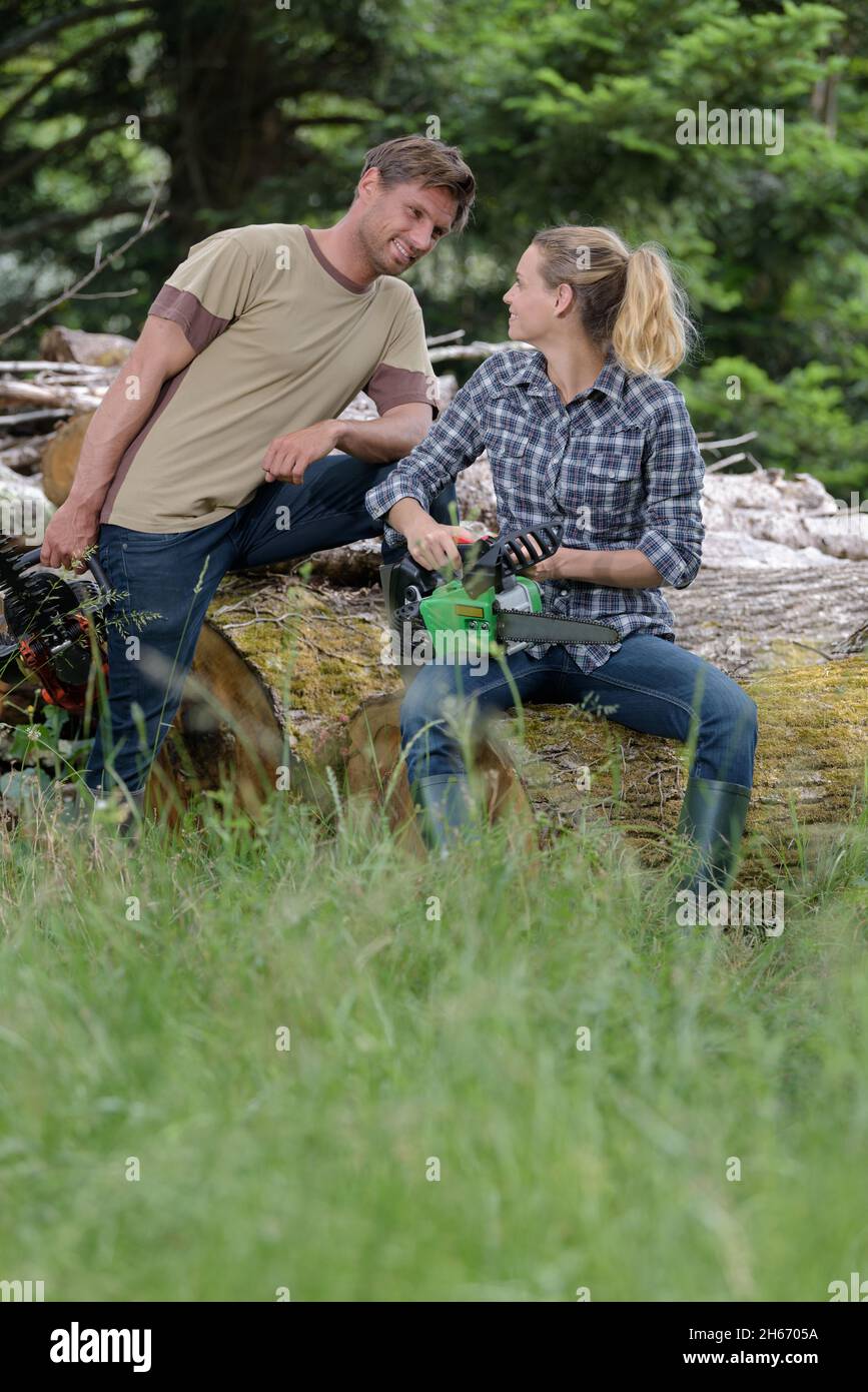 couple in the woods with chainsaws Stock Photo - Alamy