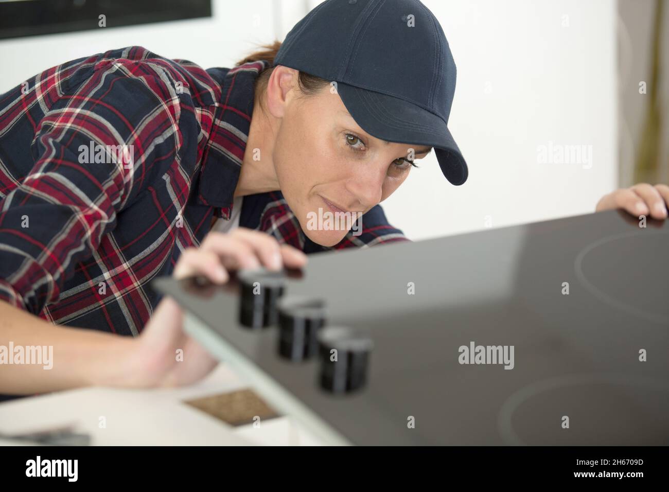 installing a new hob in modern kitchen Stock Photo - Alamy