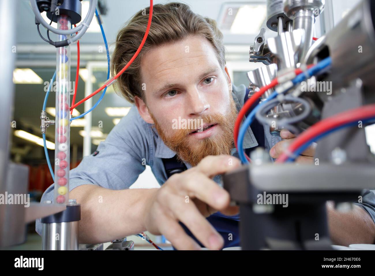 engineer maintaining hydraulic factory machine Stock Photo - Alamy