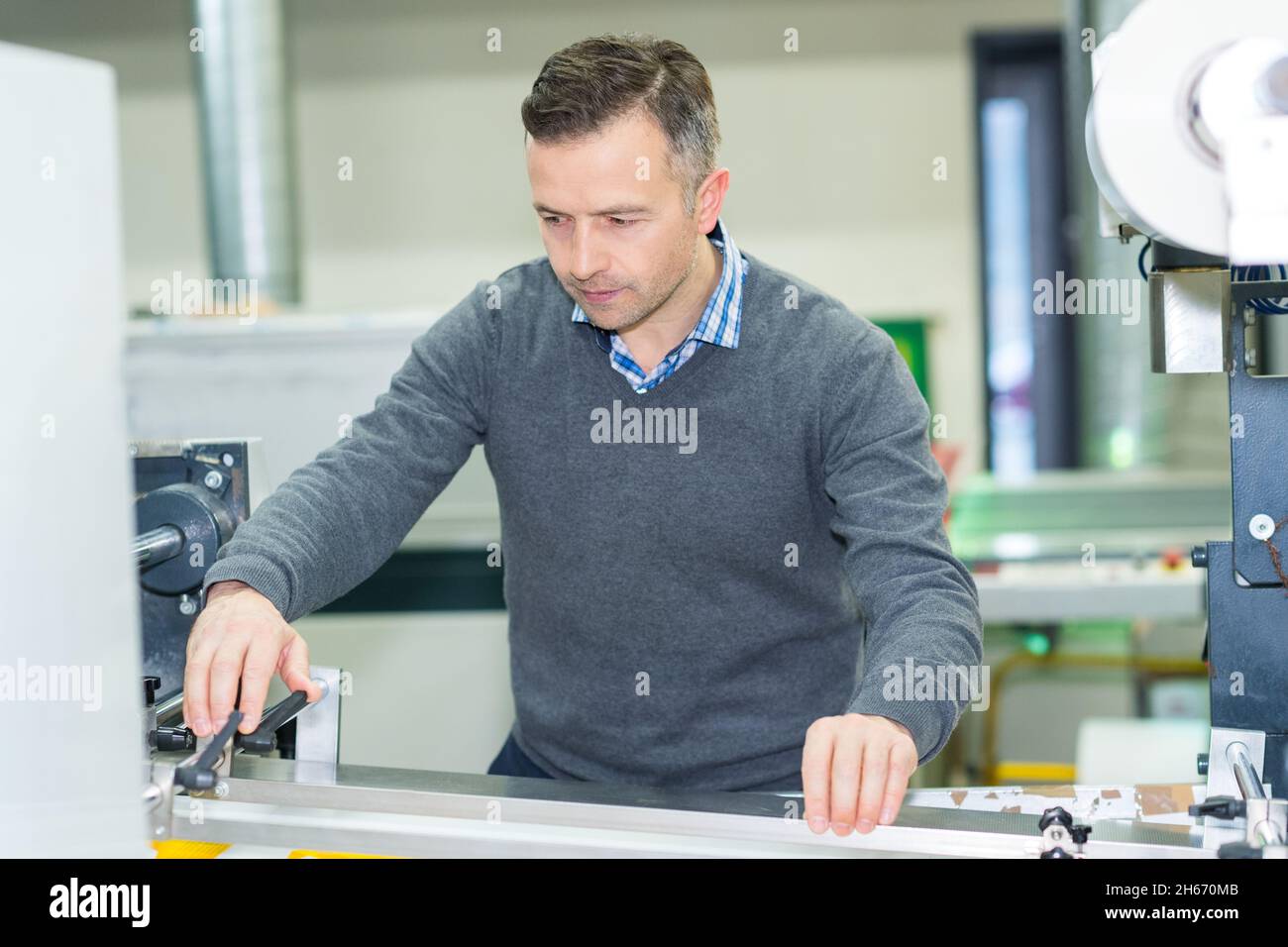 press operator produces printing Stock Photo - Alamy