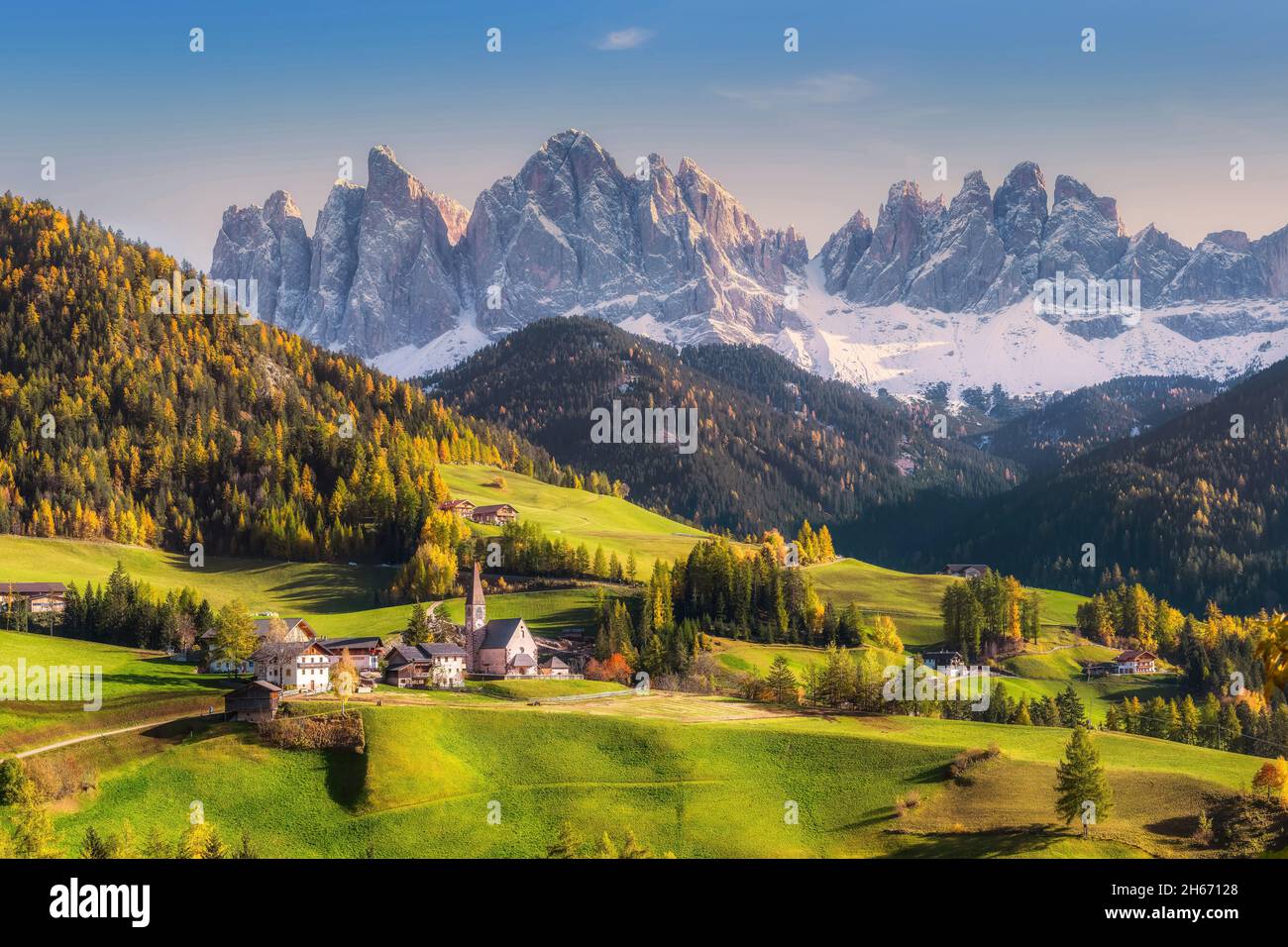 Rural landscape with church in valley and mountain peaks Stock Photo ...