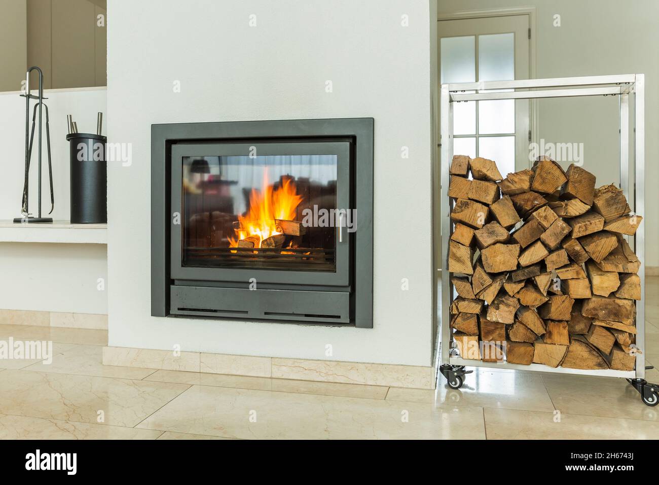 Luxurious modern design fireplace burning firewood, door with fire ...
