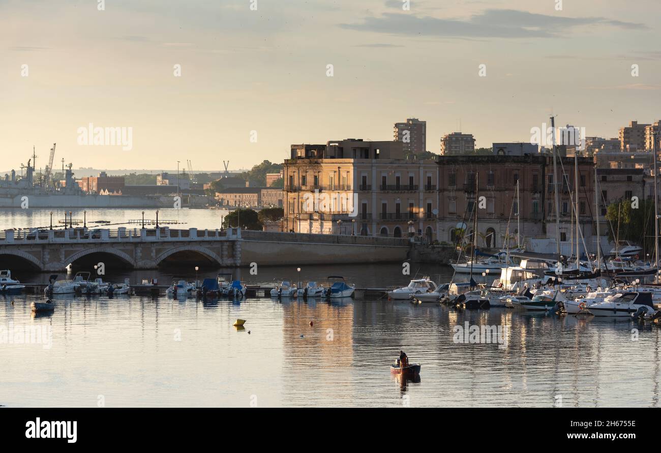 Sea port. Ships and boats at dawn. Sea town. Taranto Stock Photo - Alamy
