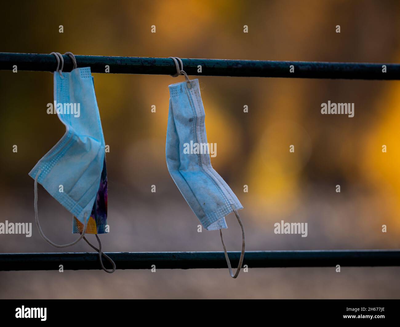 Face masks tied to a steel rail blow in the wind in Calgary, Alberta ...