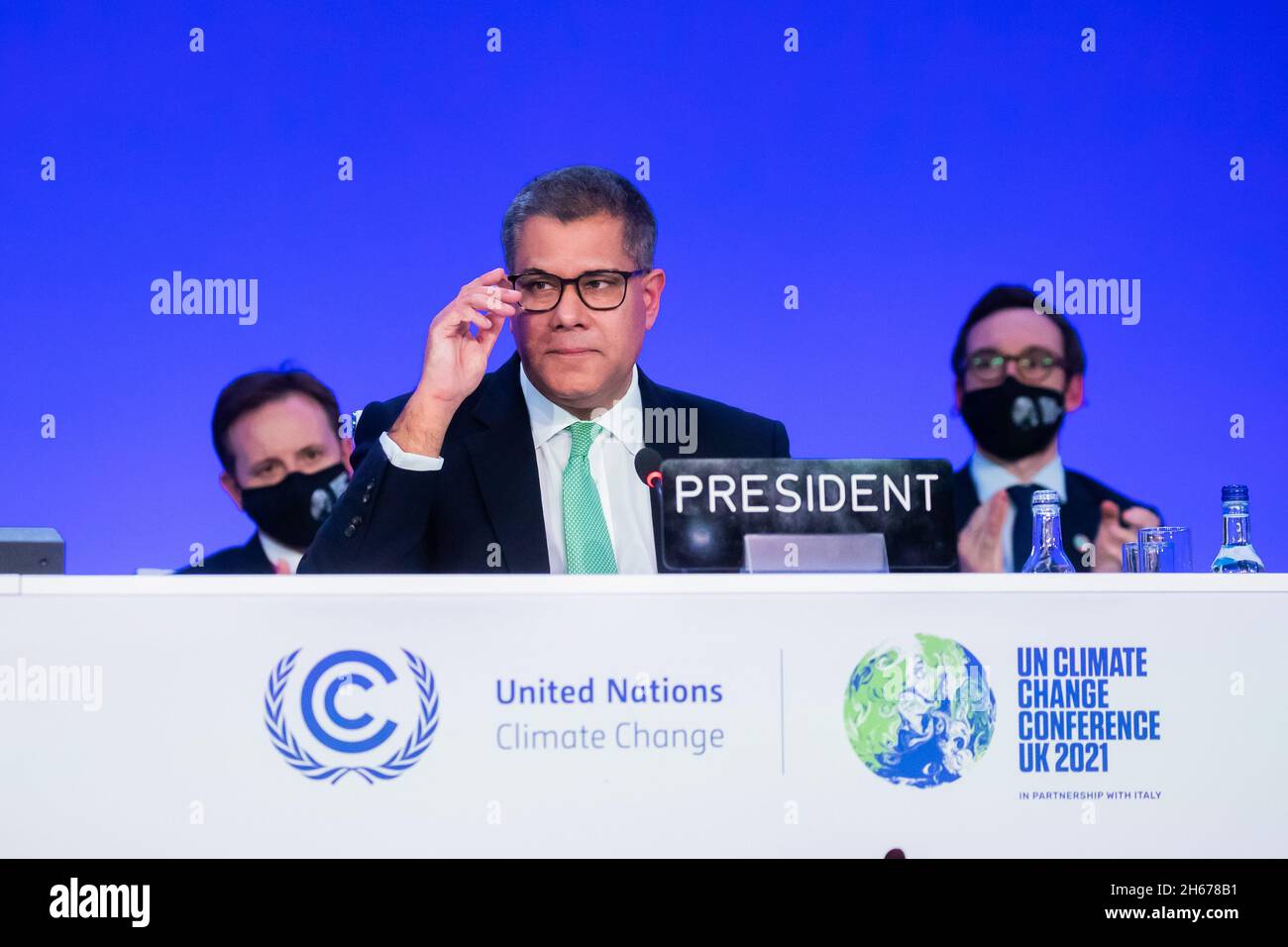 Glasgow, UK. 13th Nov, 2021. Alok Sharma (M), President of COP26, grabs ...