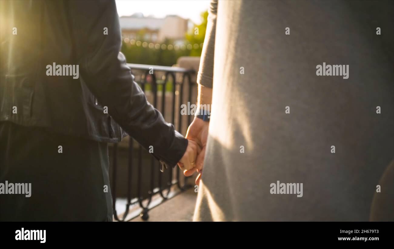 Affectionate couple romantically holding hands hi-res stock photography ...