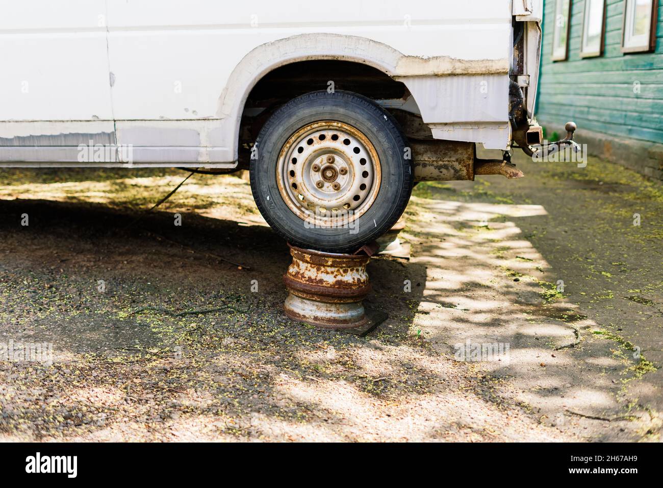 Old rusty car wheel. Cracked tires and a rusted hubcaps Stock Photo - Alamy