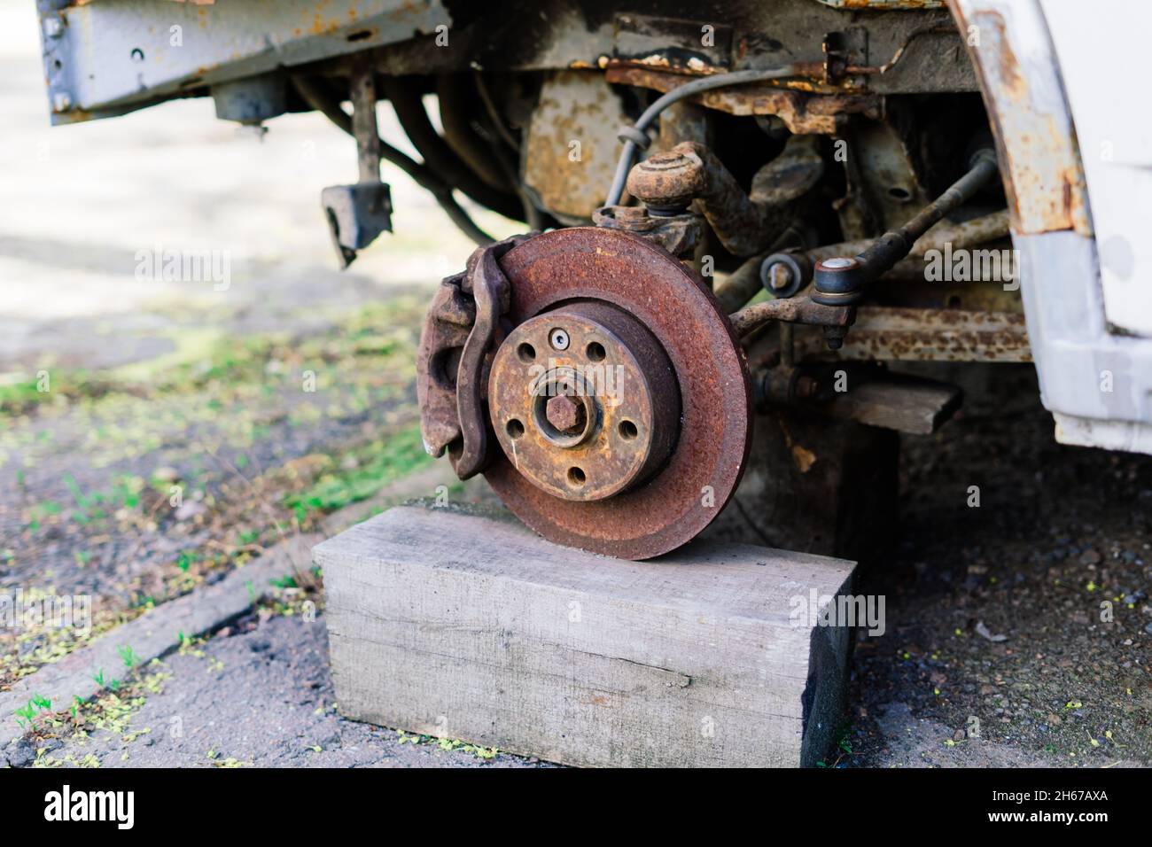 Old rusty car wheel. Cracked tires and a rusted hubcaps Stock Photo - Alamy