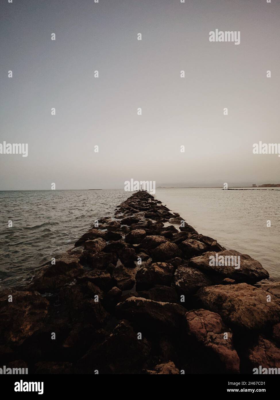 Long rocky pathway on the sea on the coast Stock Photo - Alamy