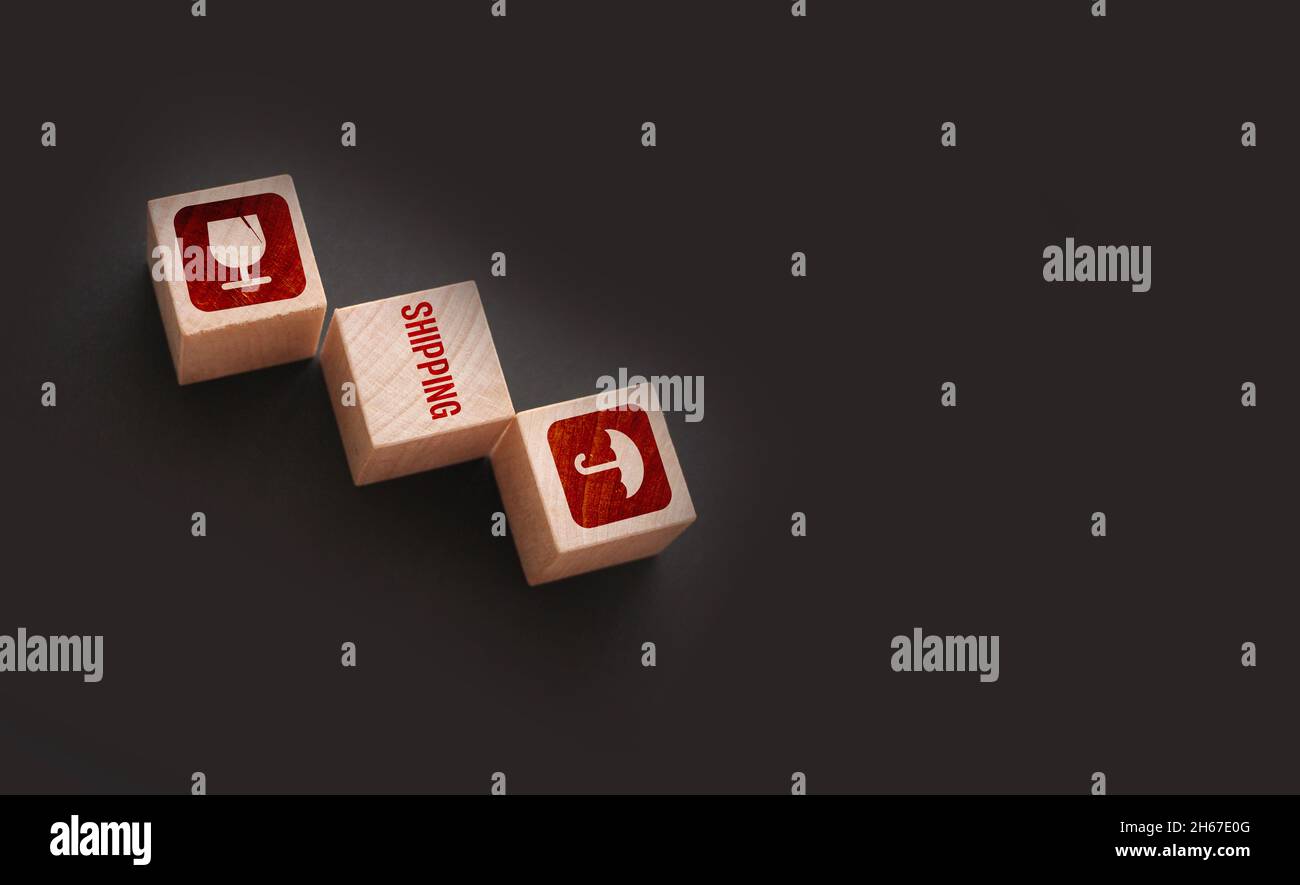 Shipping word and icons engraved on a wooden cubes, isolated on black ...