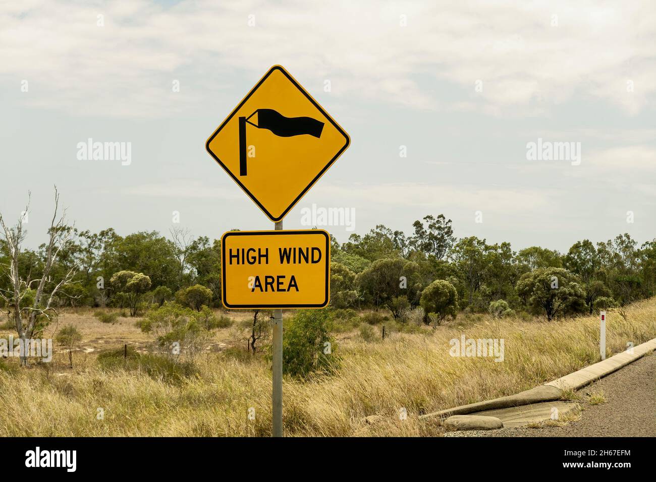 Roadside signage warning of a high wind area ahead Stock Photo - Alamy