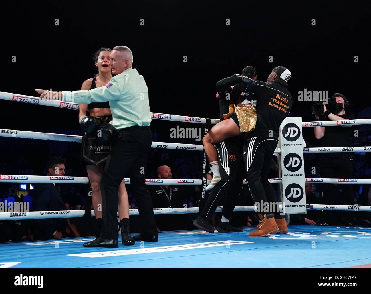Alycia Baumgardner (right) celebrates victory by knockout against Terri ...