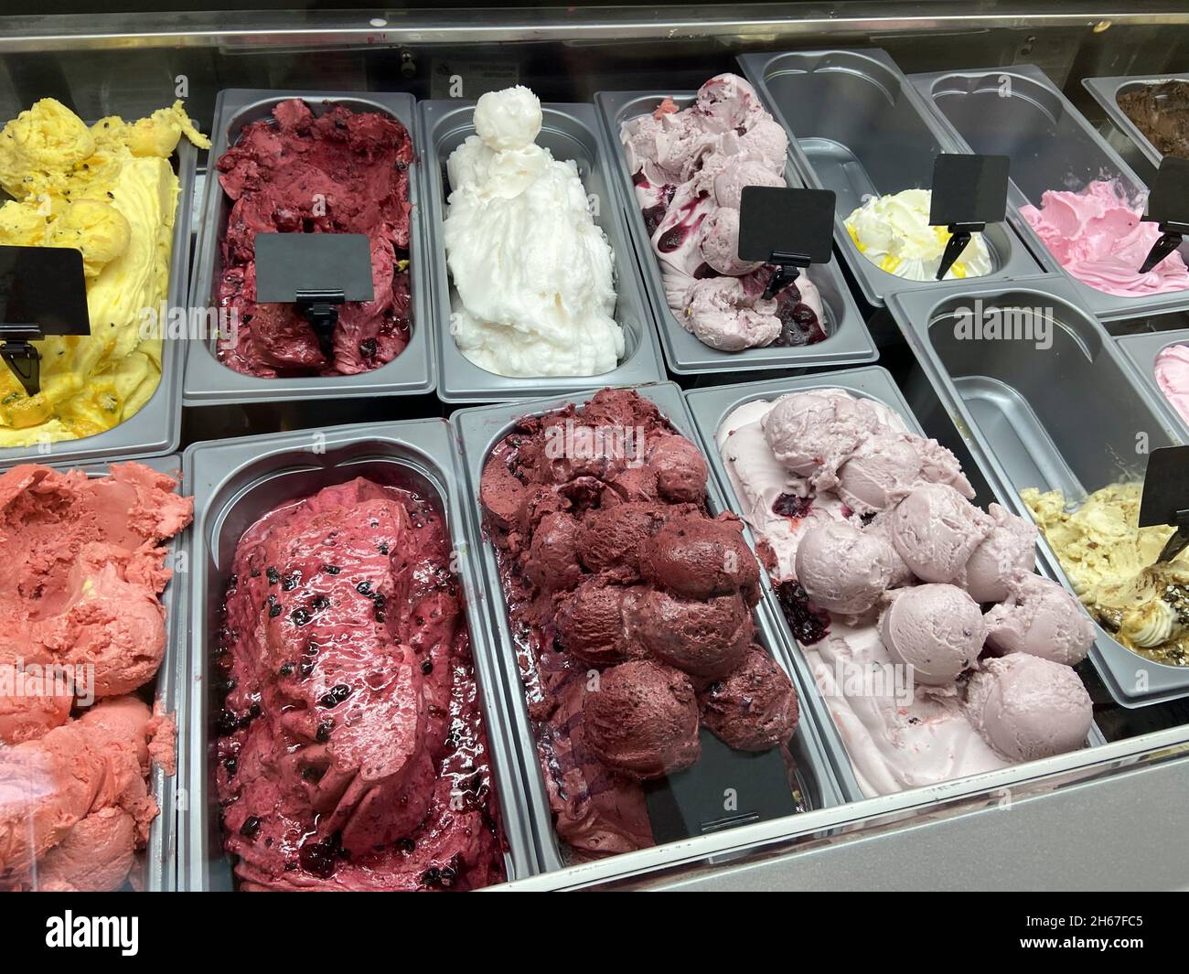 A multi-colored dessert, ice cream of different flavors, on the ...