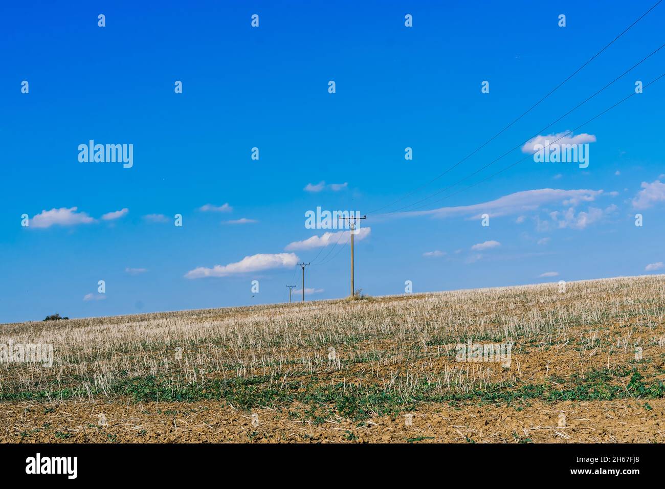 Electric power transmission lines at sky background, an autumn field ...
