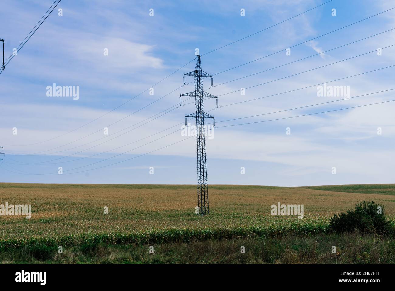 Electric power transmission lines at sky background, an autumn field ...
