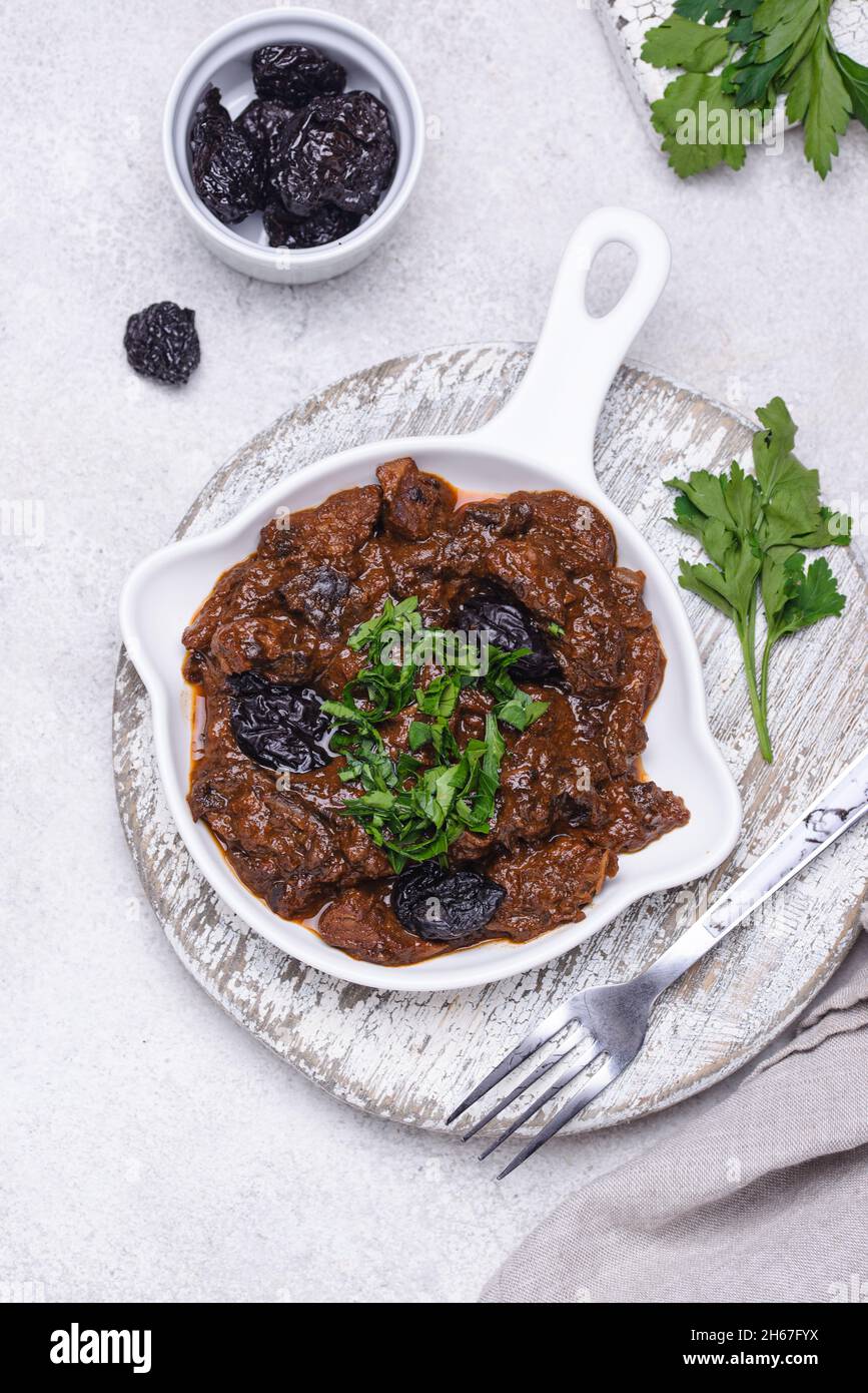 Hot stewed meat with prunes Stock Photo - Alamy