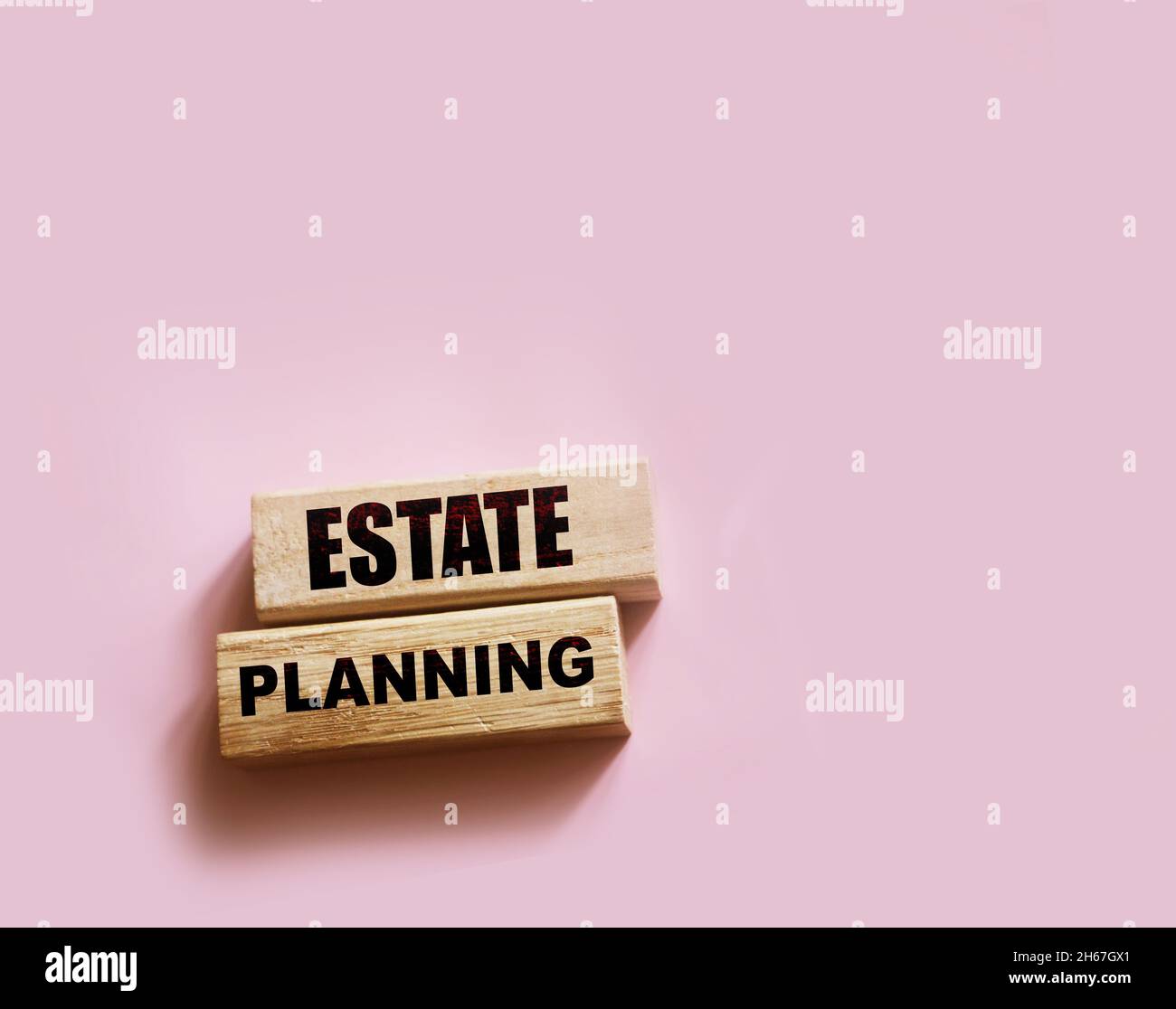Estate planning on Wooden blocks on pink background. Real estate ...