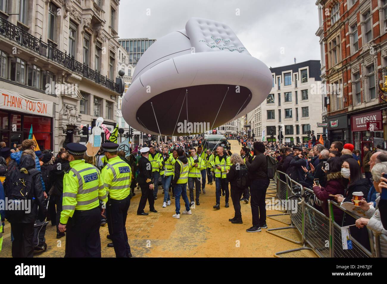 London, UK. 13th Nov, 2021. Participants carry a giant inflatable hard ...