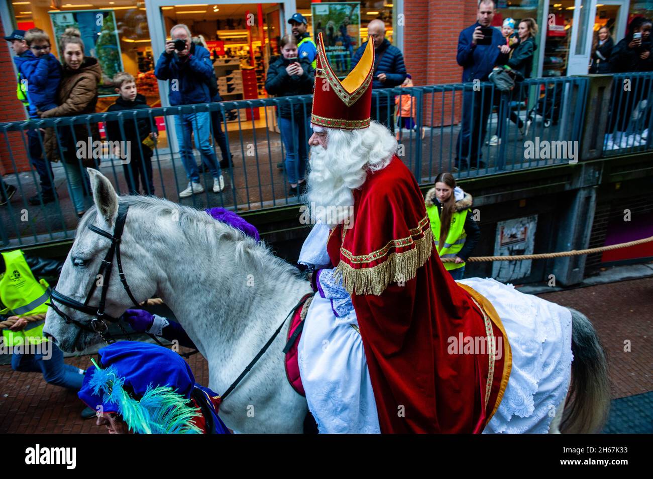 People are seen taking photos of St. Nicholas arriving at the center of ...