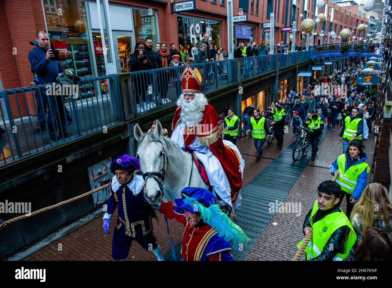 St. Nicholas is seen on the street riding his white horse called ...