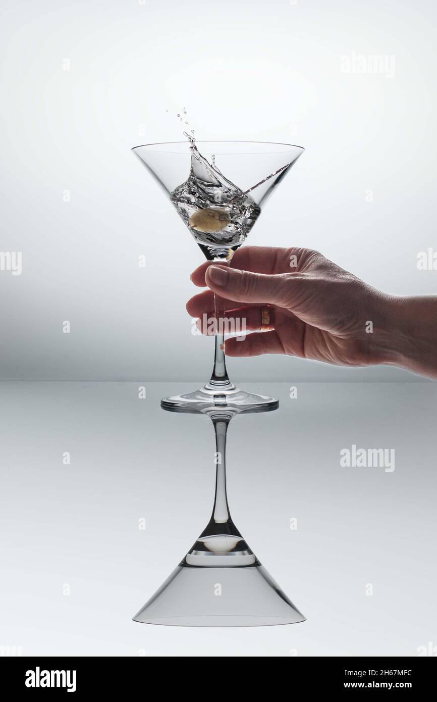 A cocktail glass with a martini splash Stock Photo - Alamy