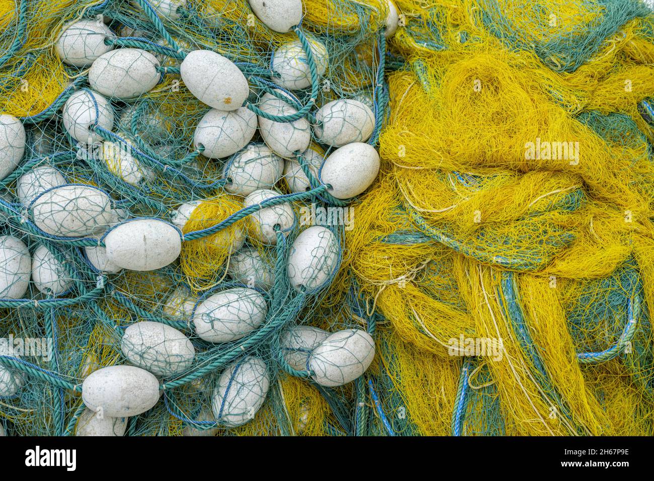 Closeup of a tangled nylon fishing net with white floats Stock Photo ...