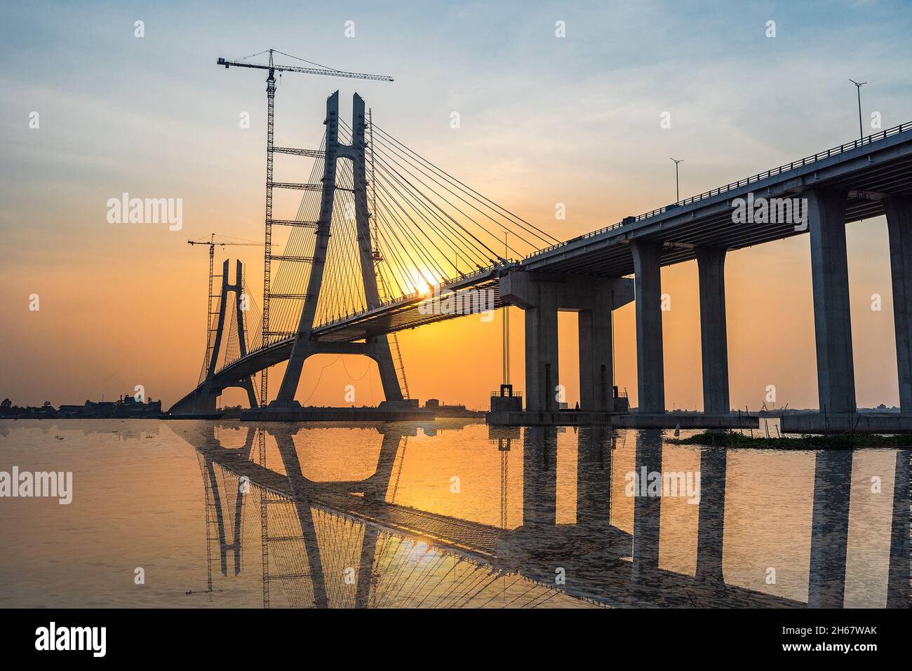 Sunset at Vam Cong bridge on the Mekong river Stock Photo - Alamy