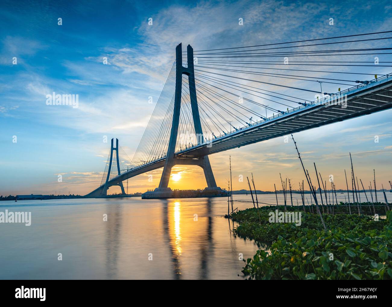 Sunset at Vam Cong bridge on the Mekong river Stock Photo - Alamy