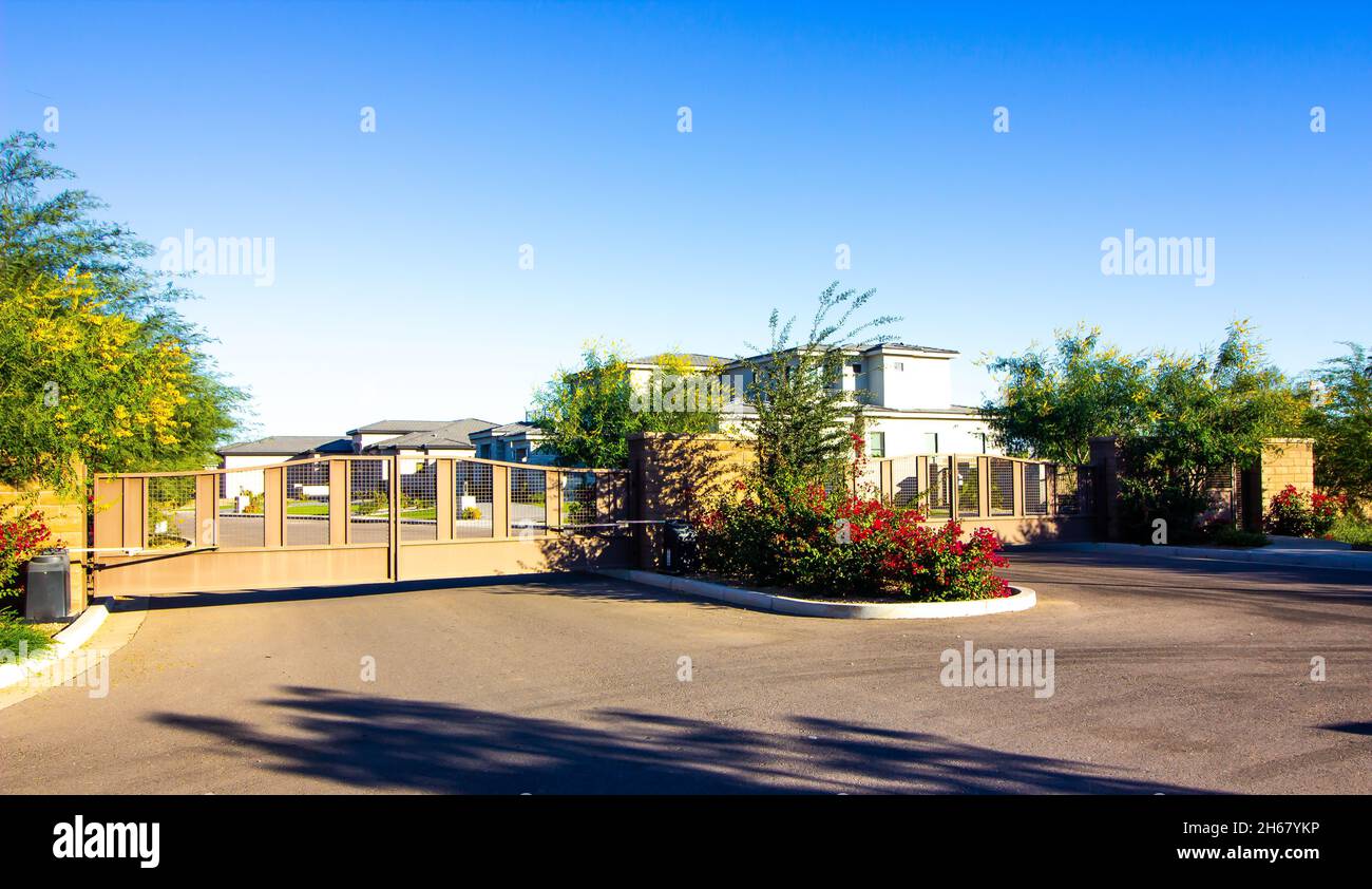 Metal Entrance And Exit Gates At Secure Housing Subdivision Stock Photo ...