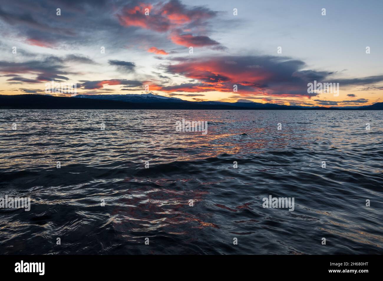 Pastel, pink, orange sunset over stunning natural lake in northern ...