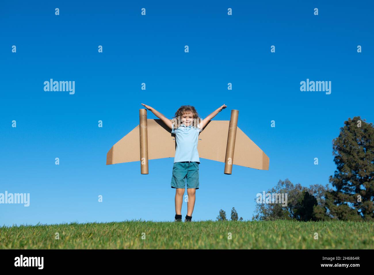 Boy child with wings at sky imagines a pilot and dreams of flying. Kids ...