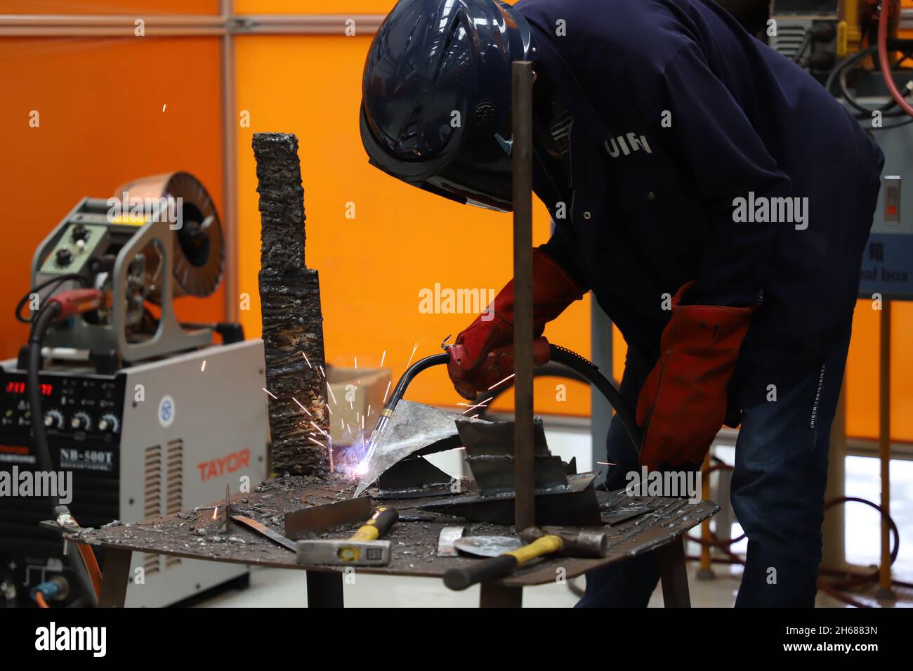 Mukono, Uganda. 9th Nov, 2021. A local trainee performs welding ...