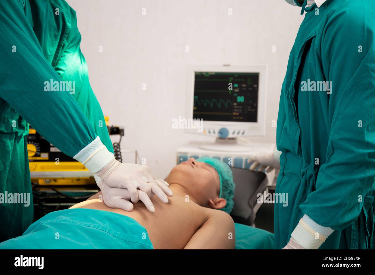 Hands of doctor and surgeon CPR pump heart of patient emergency on ...