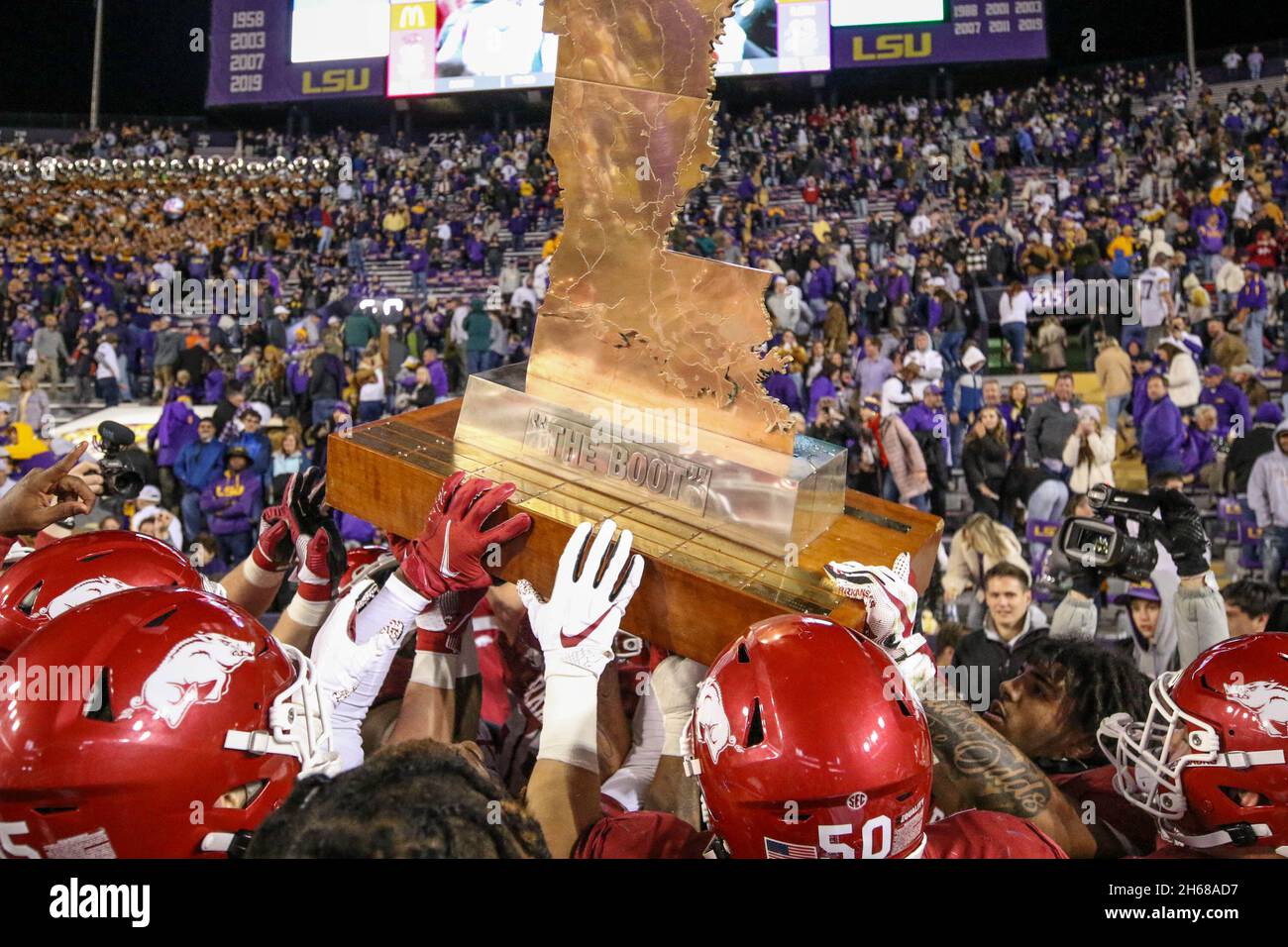 Baton Rouge, LA, USA. 13th Nov, 2021. Arkansas players rush to hold up ...
