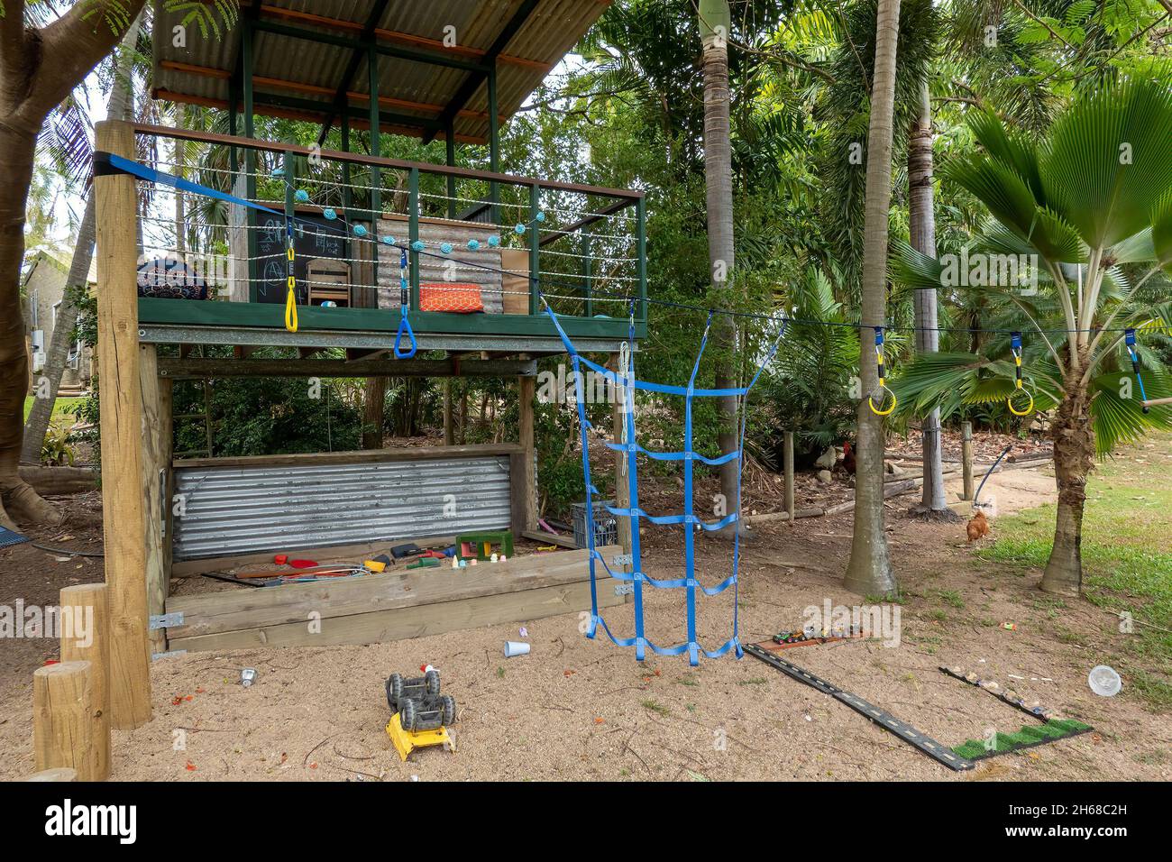 A cubby house for children high above a sand pit and gym Stock Photo ...