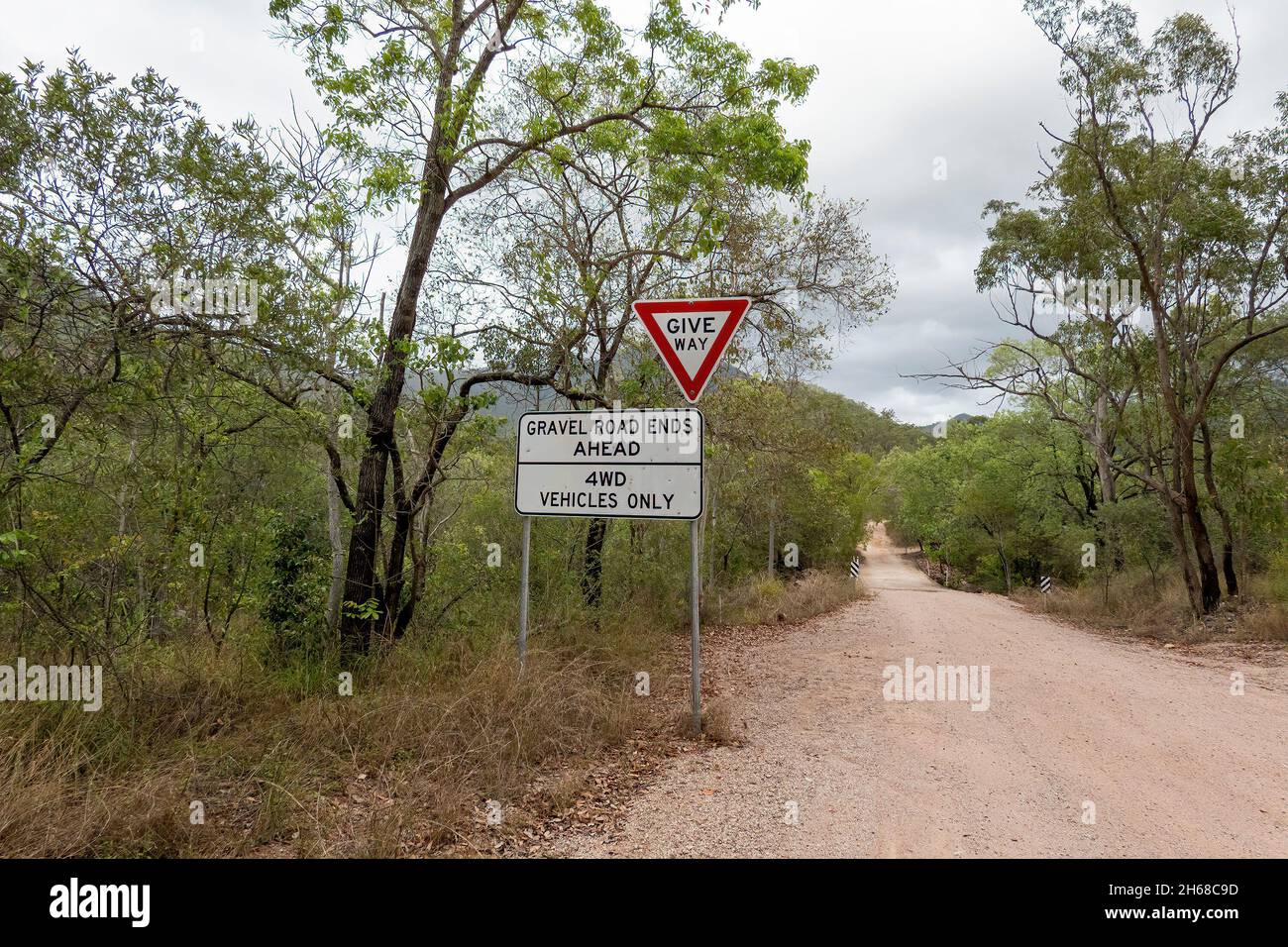 Signage on a country dirt road warning that the gravel road ends ahead ...