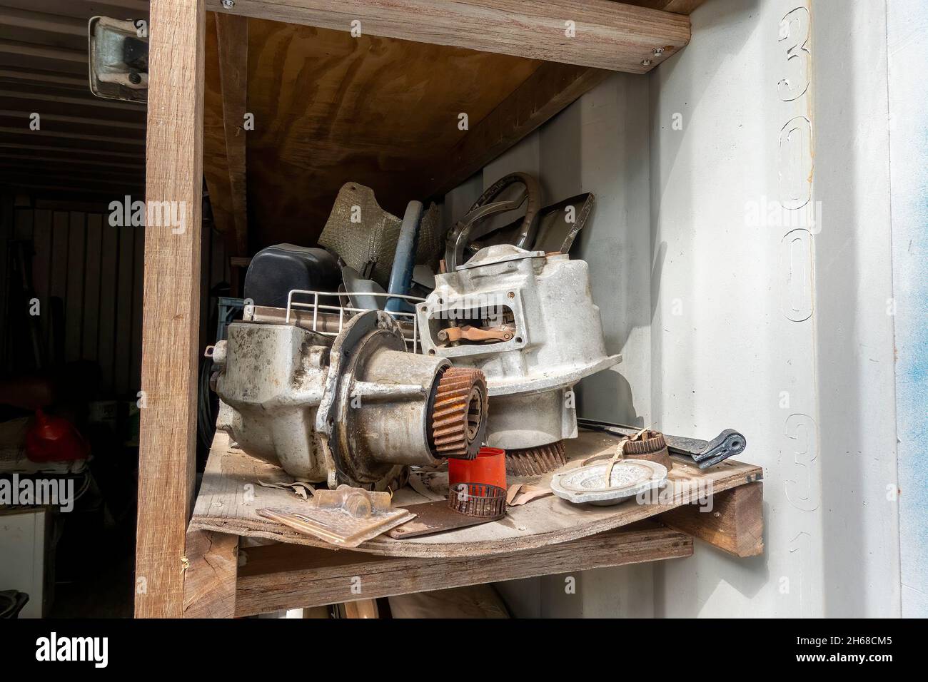 Pieces of car engine parts and junk stored haphazardly in a container ...