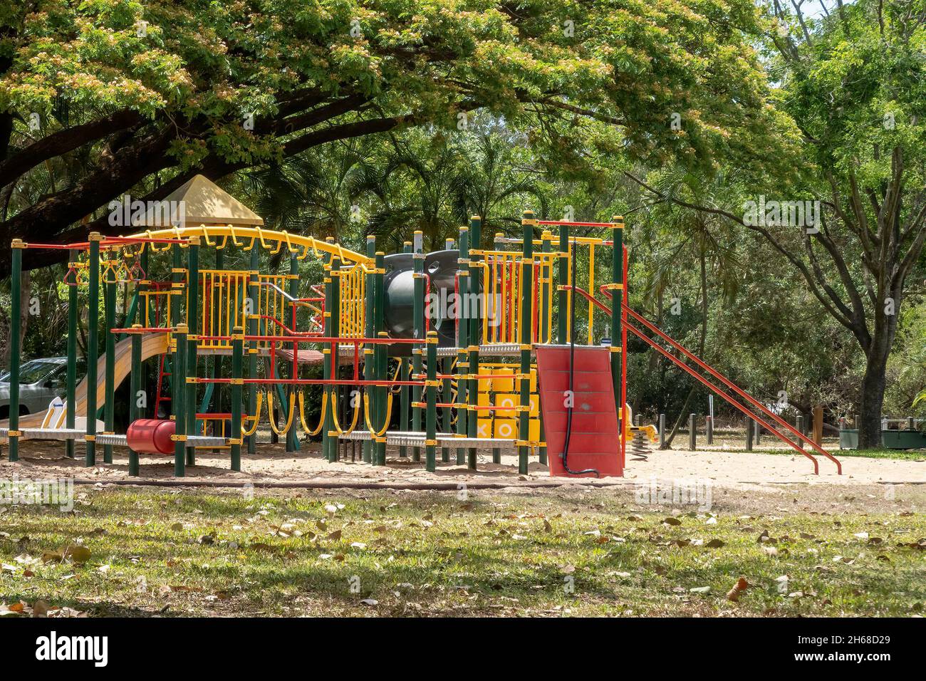 A childrens playground under large shady trees for kids to experience ...