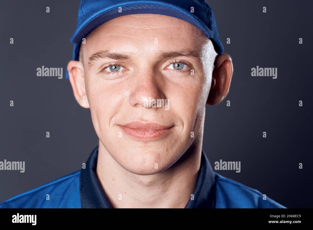man in work uniform blue cap close-up of service Stock Photo - Alamy