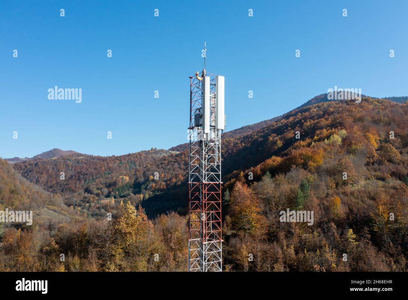 Telecommunications antenna tower in the morning. bright sunshine and ...