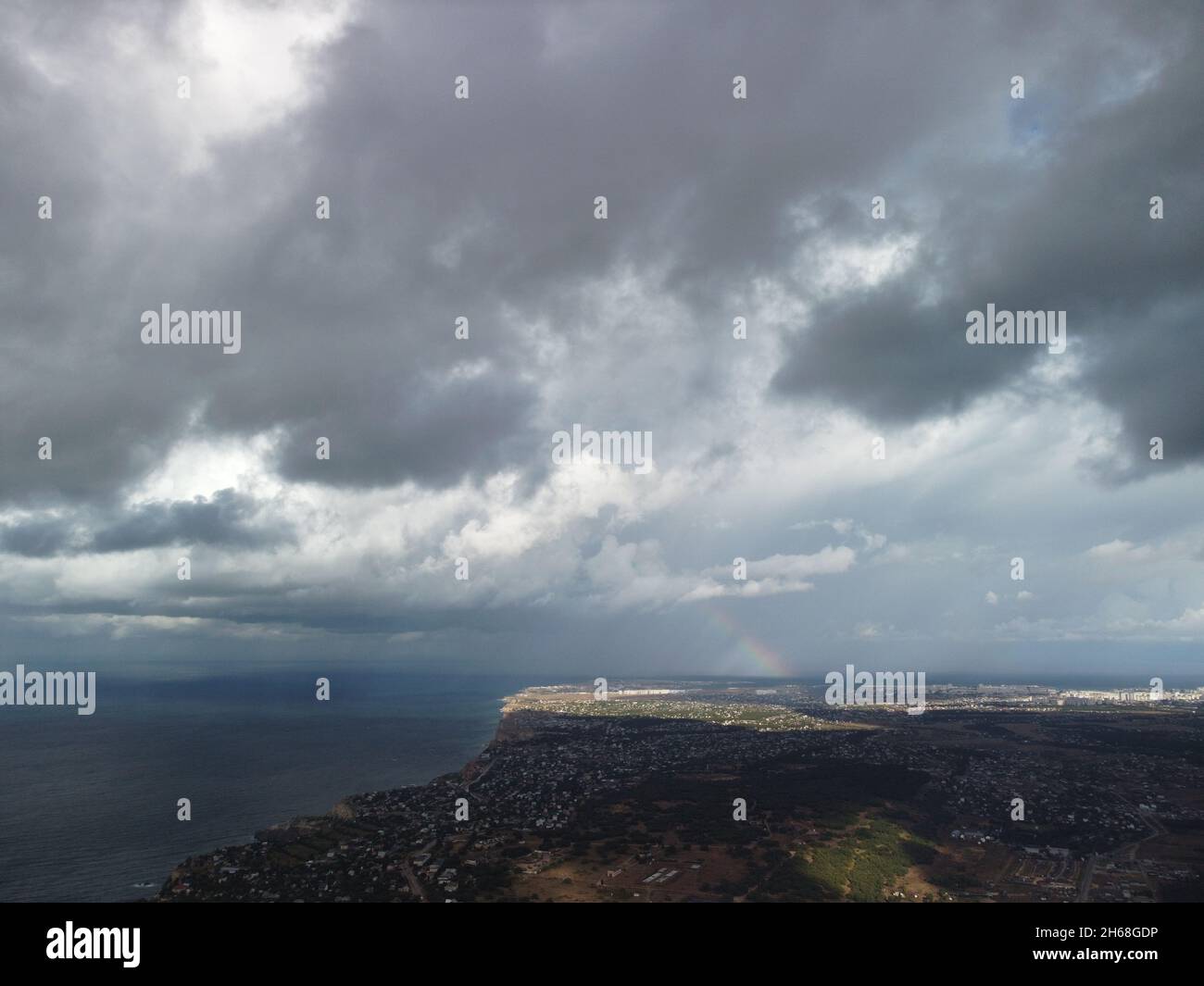 Abstract airy sky with moving plump clouds over the sea ocean. Small waves on clear water ...